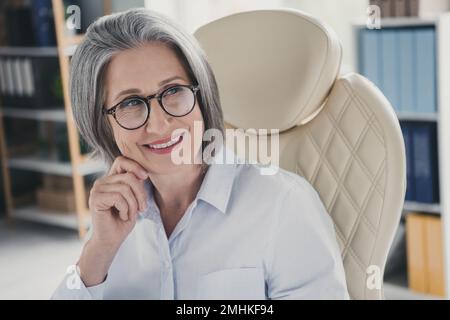 Photo of positive minded lady hand touch chin hold remote control ...