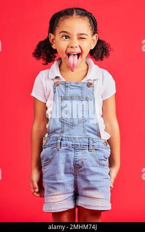 Little girl, silly and goofy face on green screen with facial expressions against a studio ...