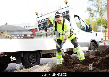 Female worker doing landscaping work Stock Photo - Alamy