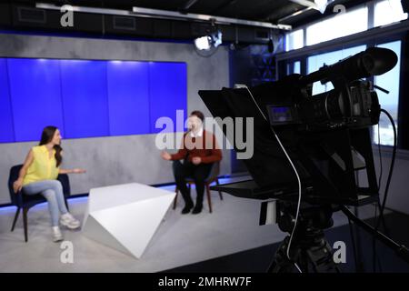 Presenters working in studio, focus on video camera Stock Photo - Alamy