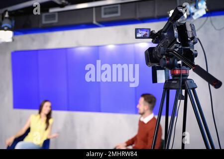 Presenters working in studio, focus on video camera Stock Photo - Alamy