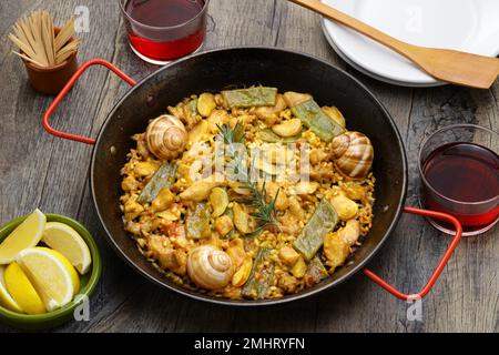Paella Valenciana (Spanish traditional rice dish); rabbit, chicken ...