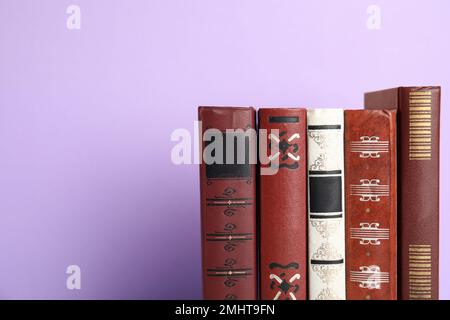 Collection of old books on violet background, space for text Stock ...