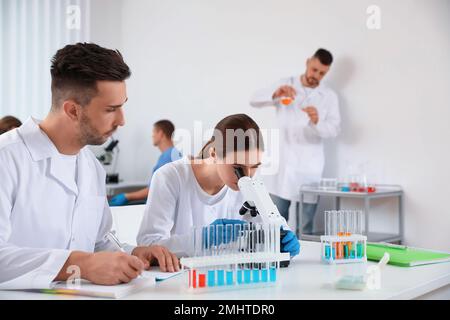 Medical students with microscope in modern laboratory Stock Photo - Alamy