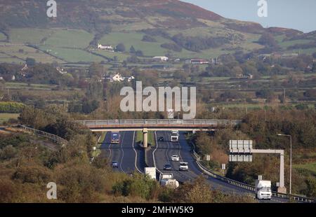 Motorists on the M1 motorway crossing the Irish border near the town of ...