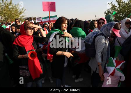 Iranian nurse Zahra Pashaei, center, cheers during an Iran and Cambodia ...