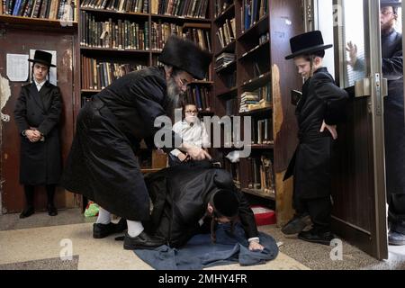 A Rabbi whips a man with leather straps as a symbolic punishment for ...