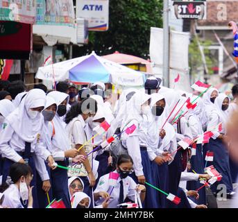 Indonesian junior high school students participating in marching (baris ...