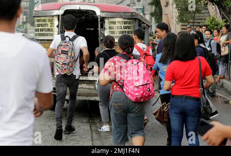 Commuters rush to board a passenger "jeepney" during a transport strike ...