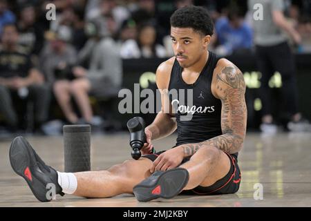 Houston guard Ramon Walker Jr. holds his knee after falling during the ...