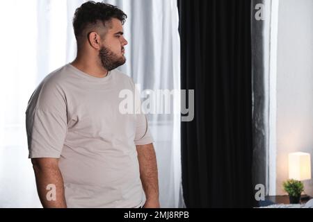 Overweight man suffering from depression at home Stock Photo - Alamy
