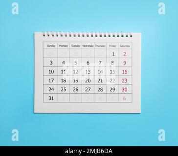 Paper calendar on light blue background, space for text. Planning ...