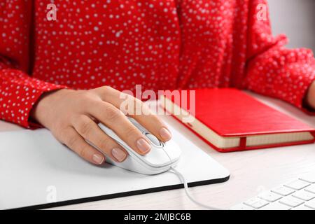 Woman using modern wired optical mouse at office table, closeup Stock ...