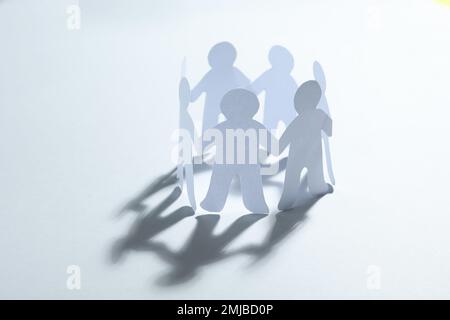 Paper people chain making circle on light blue background. Unity ...