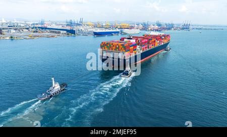 Tub Boat with Stern of cargo ship carrying container and running for ...