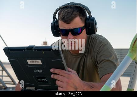 Squadron maintenance personnel perform a preflight check on a Fighter ...