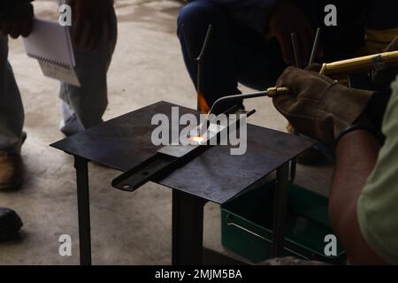 A Timor-Leste Defense Force soldier performs a vertical weld during a ...