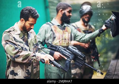 Paintball teamwork, shooting together and war game with vision, mask or ...