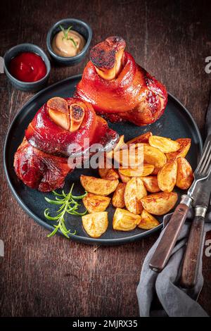 Cripsy roasted pork knuckle served with sauerkraut and potatoes ...