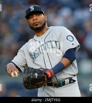 Seattle Mariners first baseman Edwin Encarnacion completes a dive onto ...