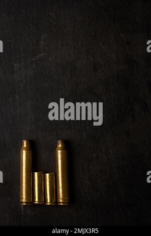 Empty bullet cartridges lying on the black background Stock Photo - Alamy
