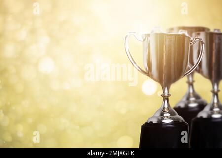 golden trophy award bokeh soft blue background. copy space for text. Winner or 1st place gold ...