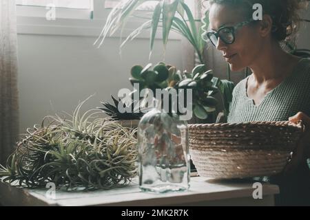 Serene female florist in greenhouse shop Stock Photo - Alamy