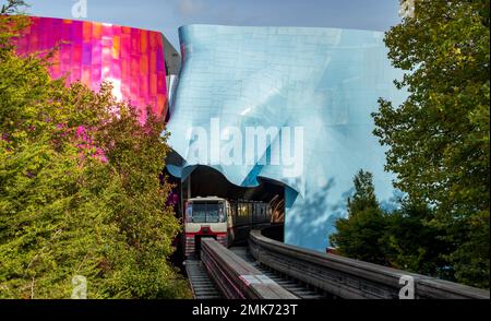 Monorail train comes out of the museum, Corrugated coloured exterior ...