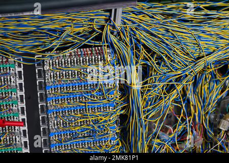 Telephone junction box with tangle of multicolour wires jointed to make ...