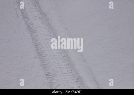 Winter trail from a car wheel in the snow, close-up Stock Photo - Alamy