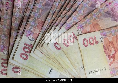 Ukrainian paper money is laid out on a blue background. 200 hryvnia ...