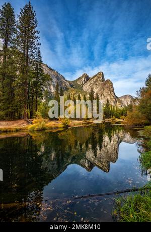 The famous Three Brothers rock formation along the Merced River in ...