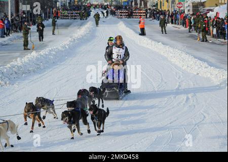 Four-time Iditarod champion Martin Buser, left, talks with his son ...