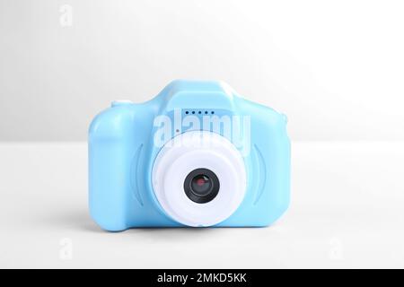 Light blue toy camera isolated on white Stock Photo - Alamy