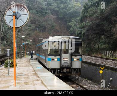 A JR Shikoku 1000 Series local train at Tsubojiri Station on the Dosan ...