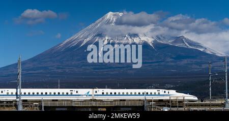 A JR Central N700 train on the Tokaido Shinkansen Line passes in front of Mount Fuji in Shizuoka ...