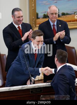 Oklahoma Lt. Gov. Matt Pinnell, left takes his oath of office with his ...
