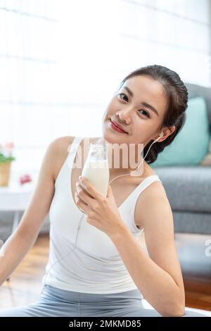 The young woman rest to drink milk after exercise Stock Photo - Alamy