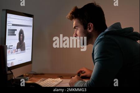 Pulling an all-nighter. a young designer working late in the office ...