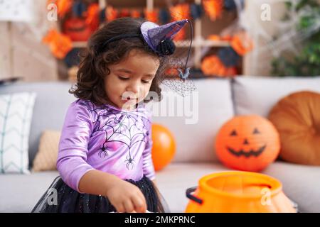 Adorable hispanic toddler having halloween party standing at home Stock ...