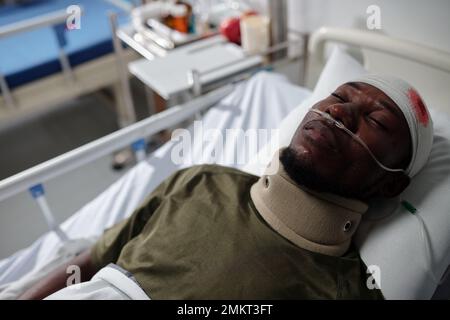 Soldier with bleeding head injury lying on hospital ward, view from ...