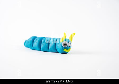 plasticine play dough wriggly worm in blue and yellow isolated on a ...