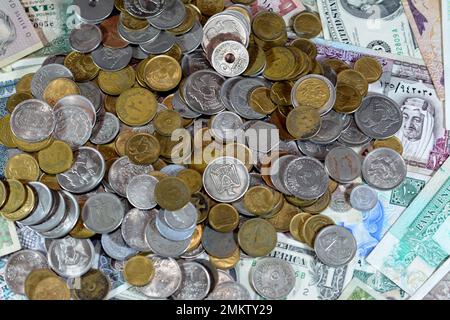 Old coins on various old cash money banknotes from different countries ...