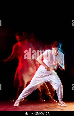 Silhouette of a person holding a red neon sword with the planet in the ...