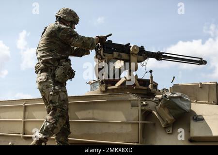 A Soldier prepares an M-2 .50 caliber machine gun at the range as he ...