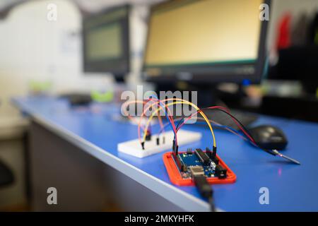 engineers assemble electrical circuits from radio components in a ...