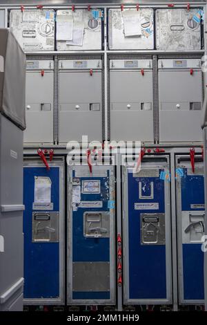 Food carts with meals for passengers on the plane. Storage space on the ...