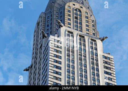 Chrysler building steel spire with gargoyles, blue sky background ...