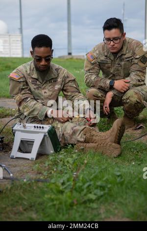 U.S. Army Sgt. Antheo Green, 44th Expeditionary Signal Battalion enhanced team chief, left, and ...