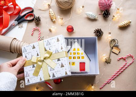 Key to house with keychain on cozy home in gift box with Christmas ...